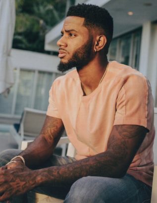 Viral Photo Of Singer Bryson Tiller Kissing Rapper NAV While Sitting On ...
